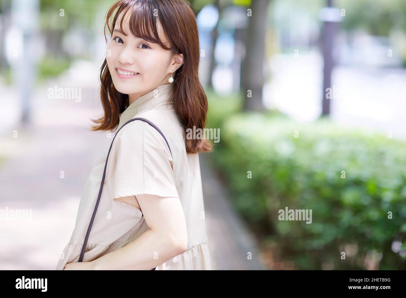 Japanese Woman Looking Back With Smile Stock Photo - Alamy