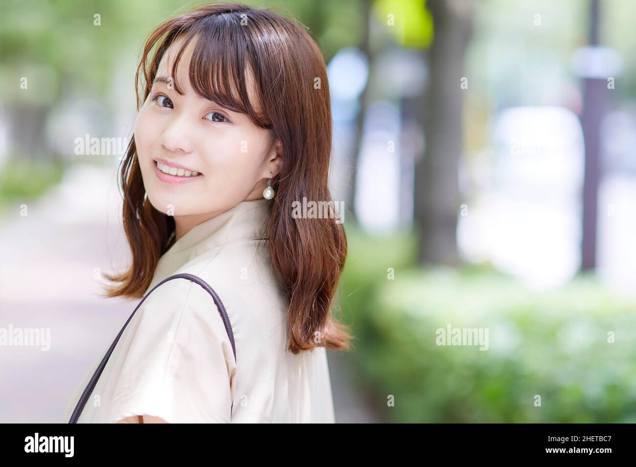 Japanese Woman Looking Back With Smile Stock Photo - Alamy