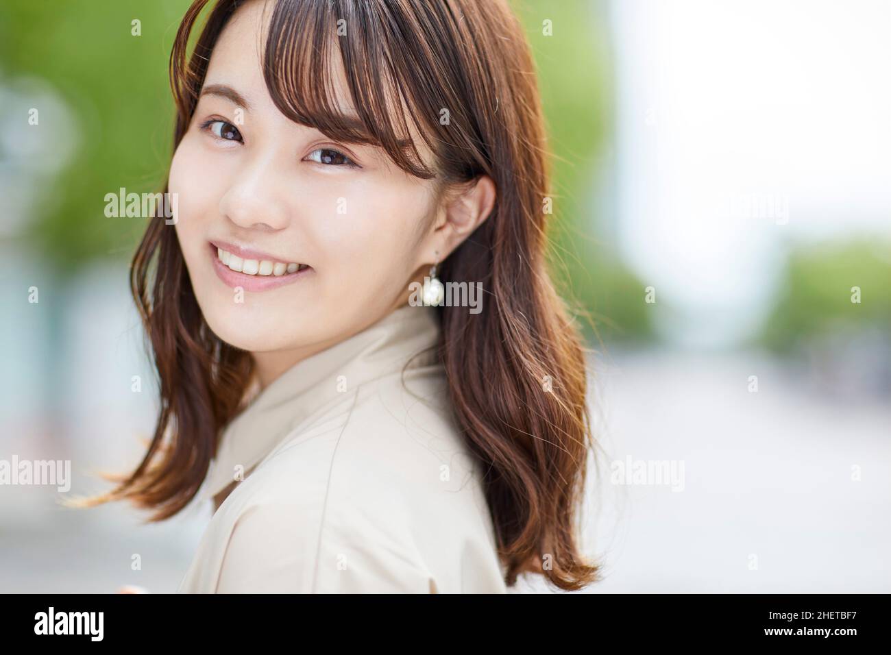 Japanese Woman Looking Back With Smile Stock Photo - Alamy