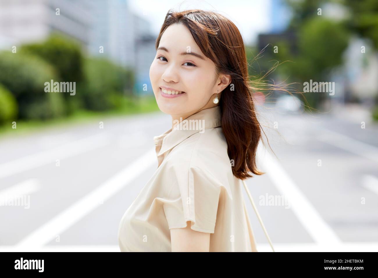 Japanese Woman Looking Back With Smile Stock Photo - Alamy