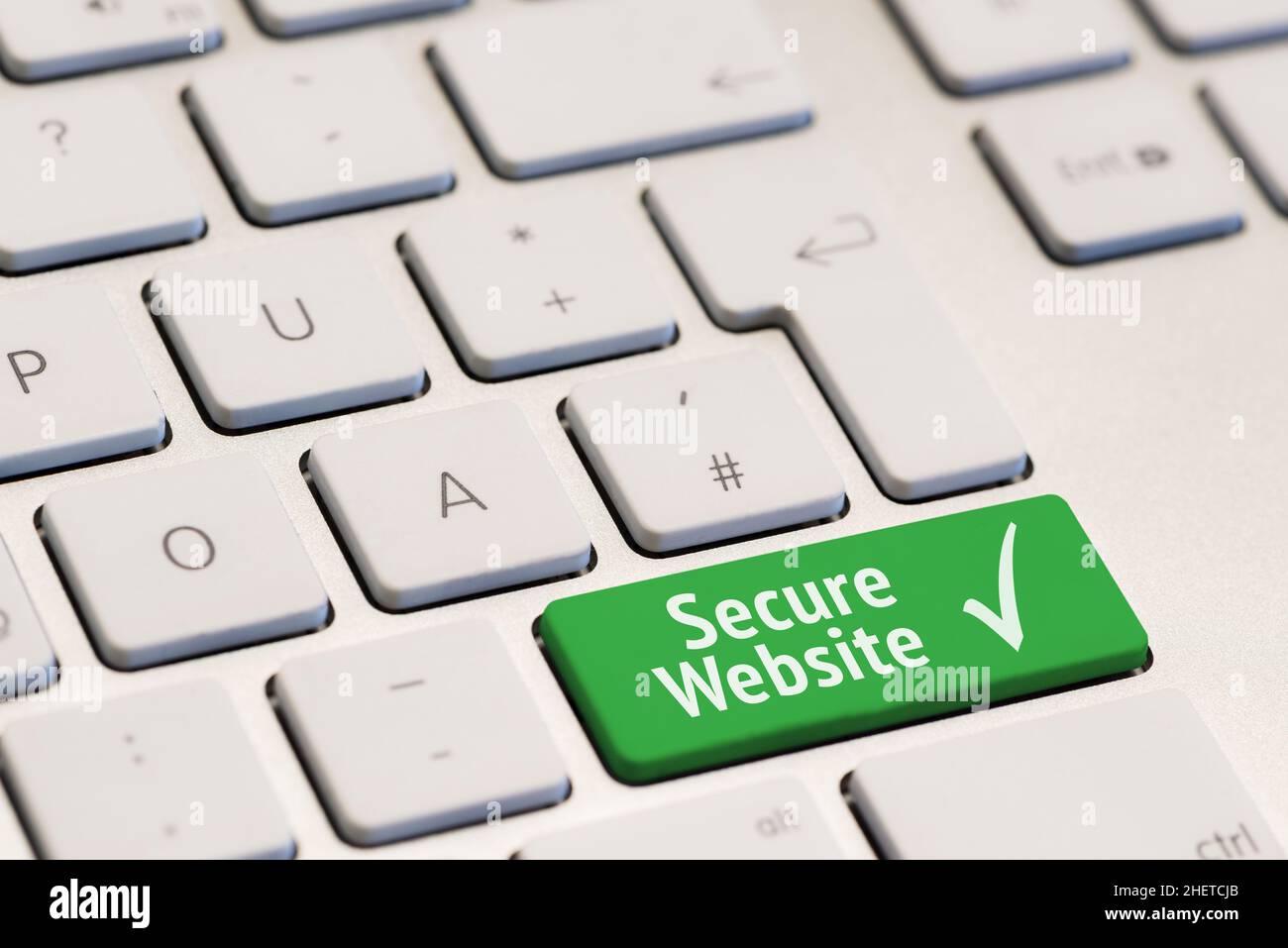 computer keyboard with the words scure website phishing on green key ...