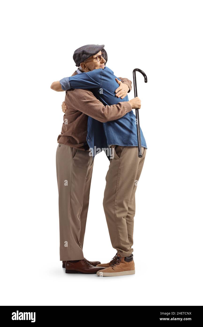 Full length shot of an elderly and young man hugging each other ...