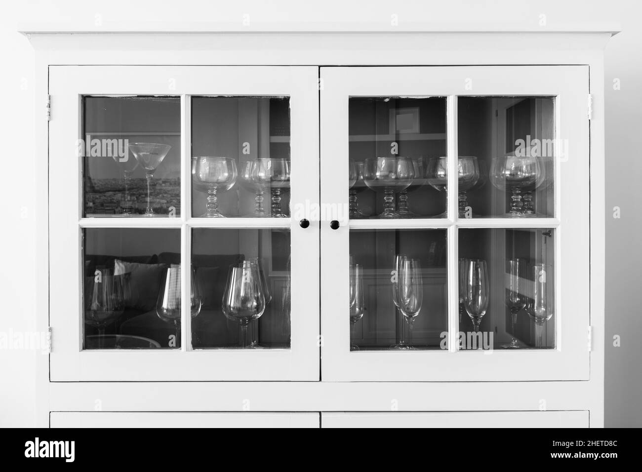 White wooden sideboard with glass doors with glassware inside Stock ...
