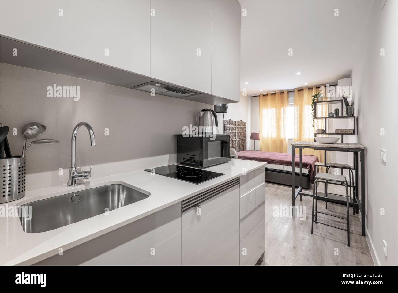 Small studio kitchen with white cabinets for vacation rental Stock ...