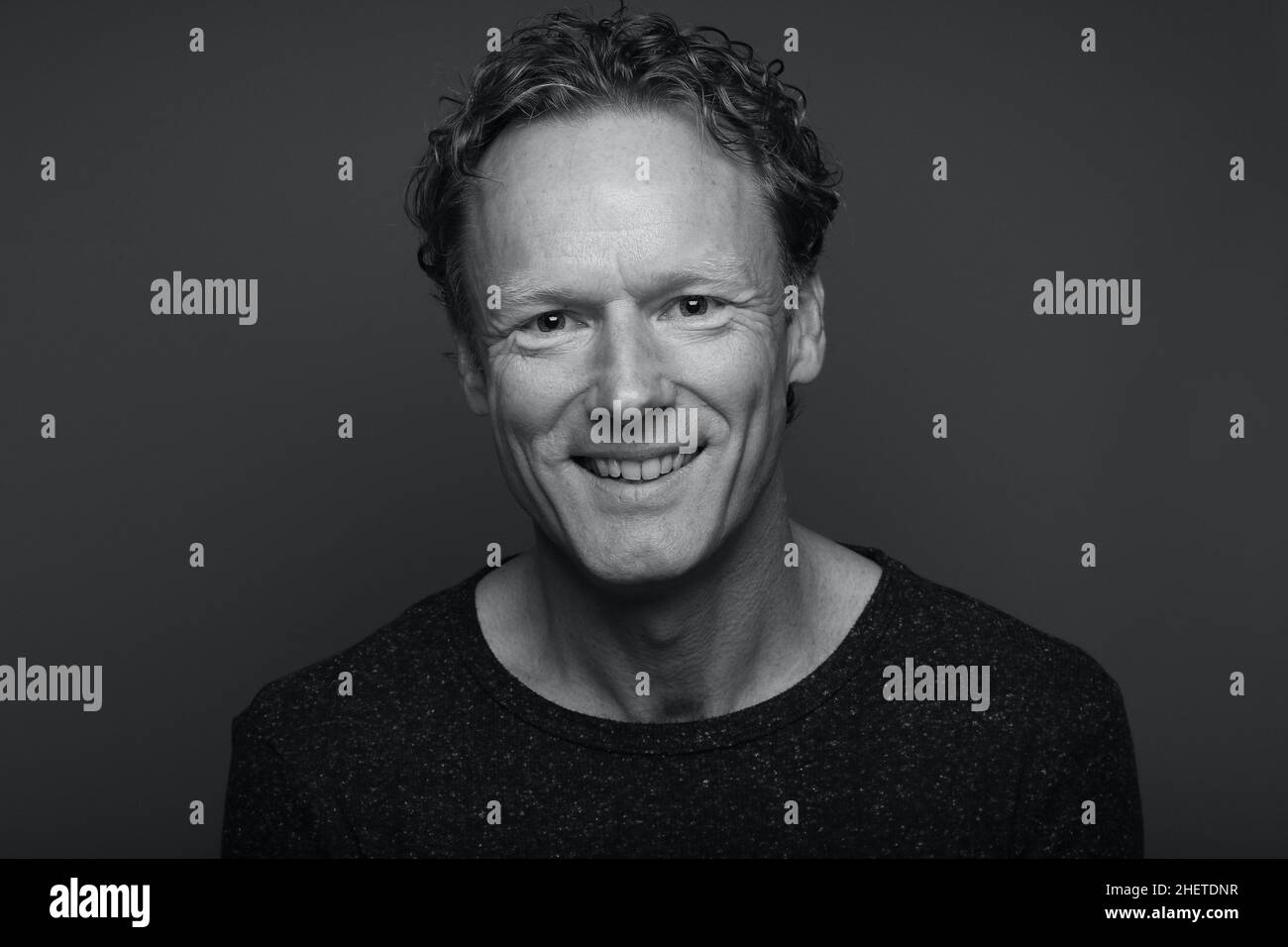 Portrait of a beautiful happy man in front of a colored background ...