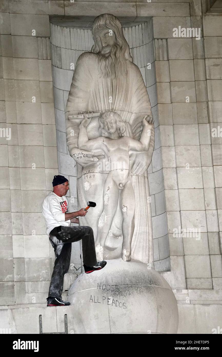 A man after he climbed onto the statues Prospero and Ariel from ...