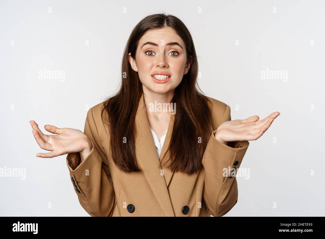 Portrait of corporate woman, office girl shrugging shoulders and ...