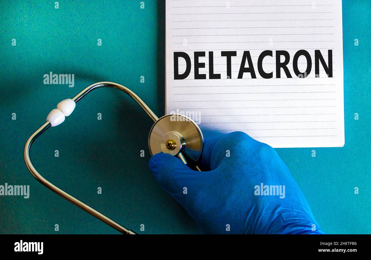 New covid-19 deltacron variant strain symbol. Hand in blue glove with ...