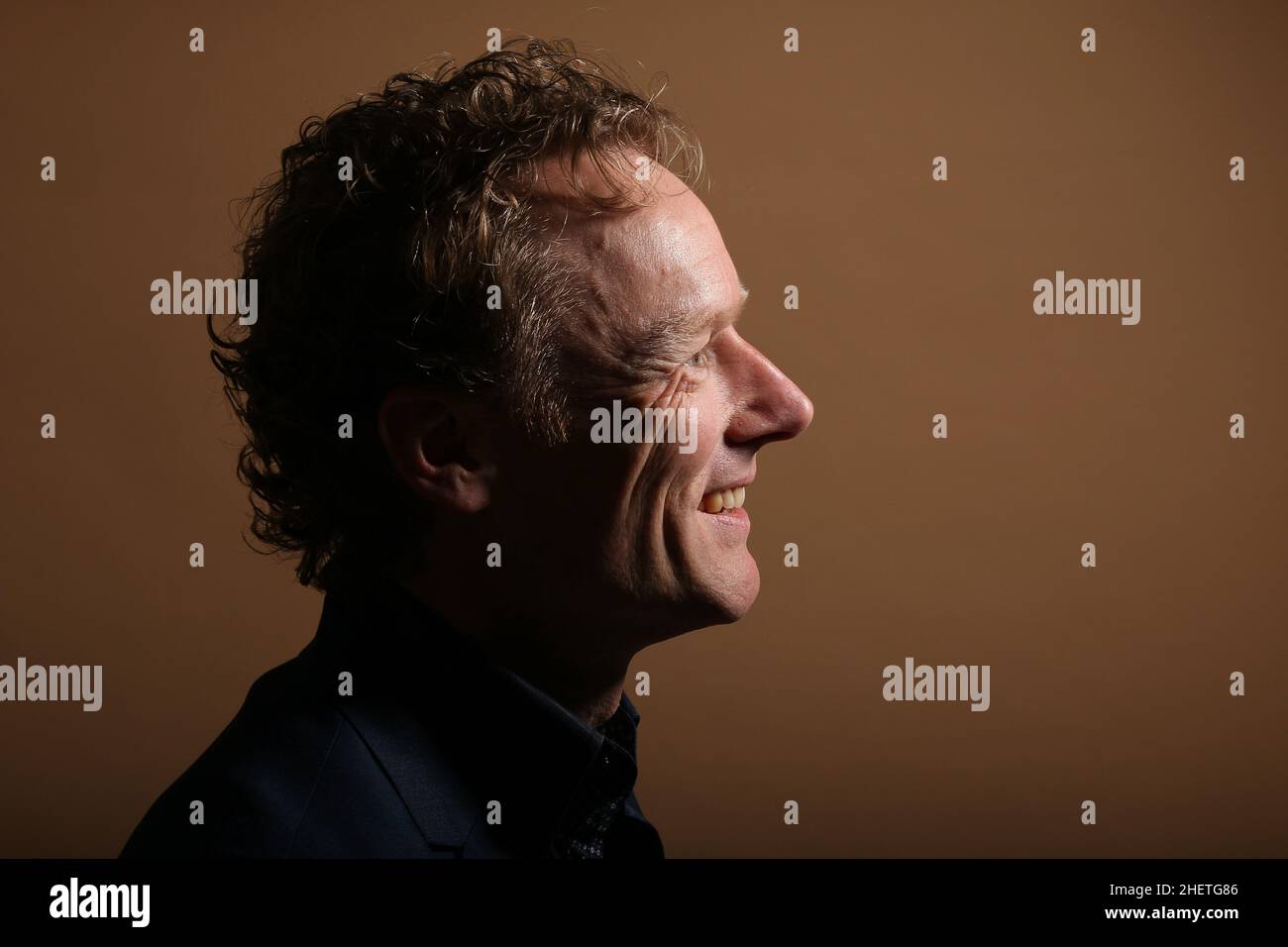 Portrait of a beautiful happy man in front of a colored background ...