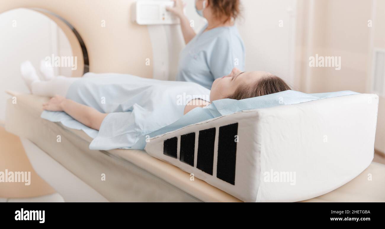 Doctor or nurse and patient with tomography CT or MRI Scan in hospital ...