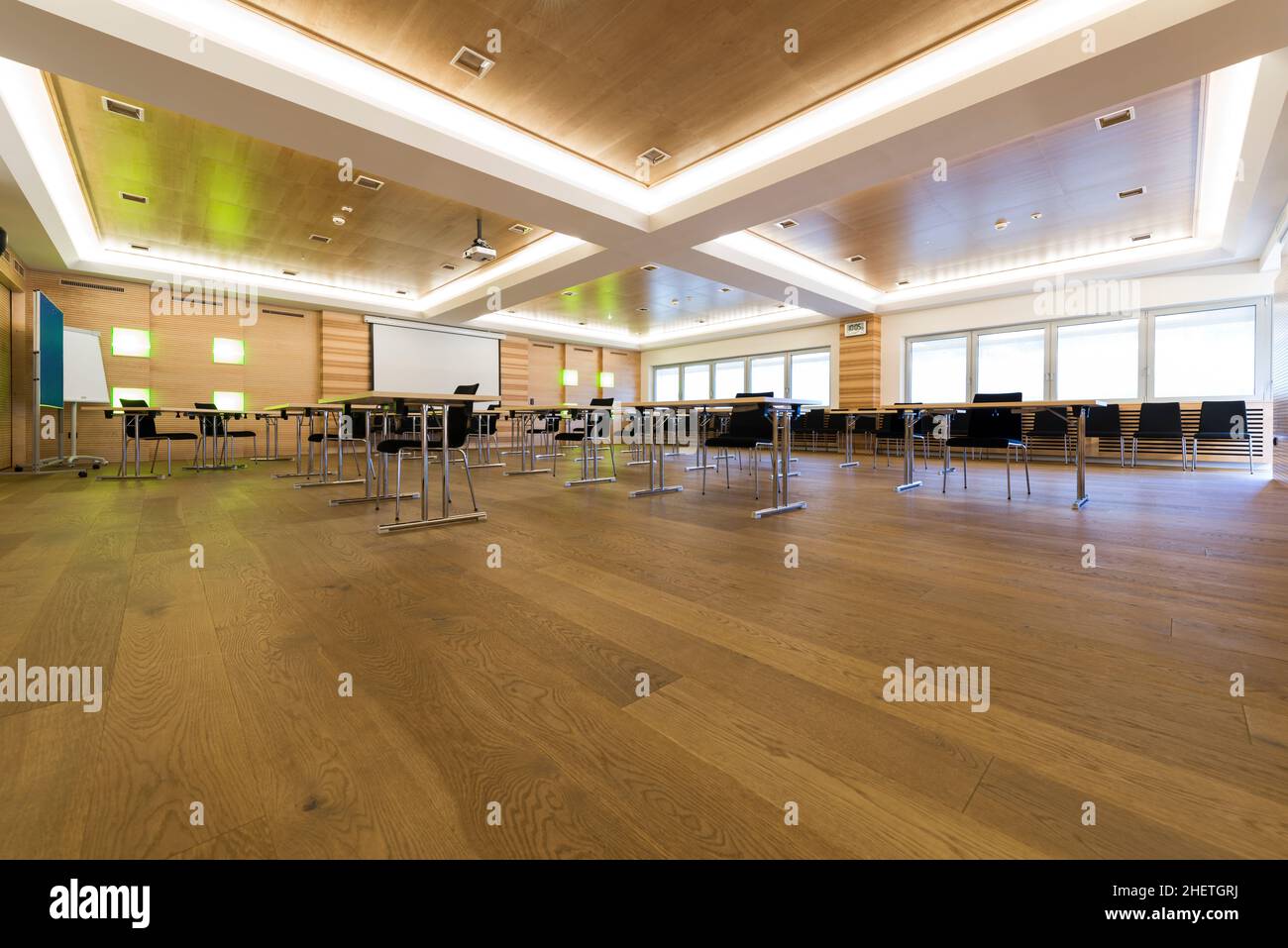 low view in wooden class or conference room with desks Stock Photo - Alamy
