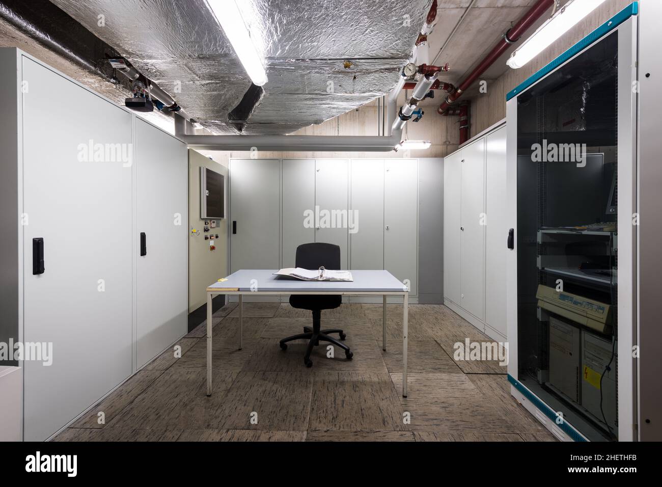 technical room with electronic equipment with table and chair Stock ...