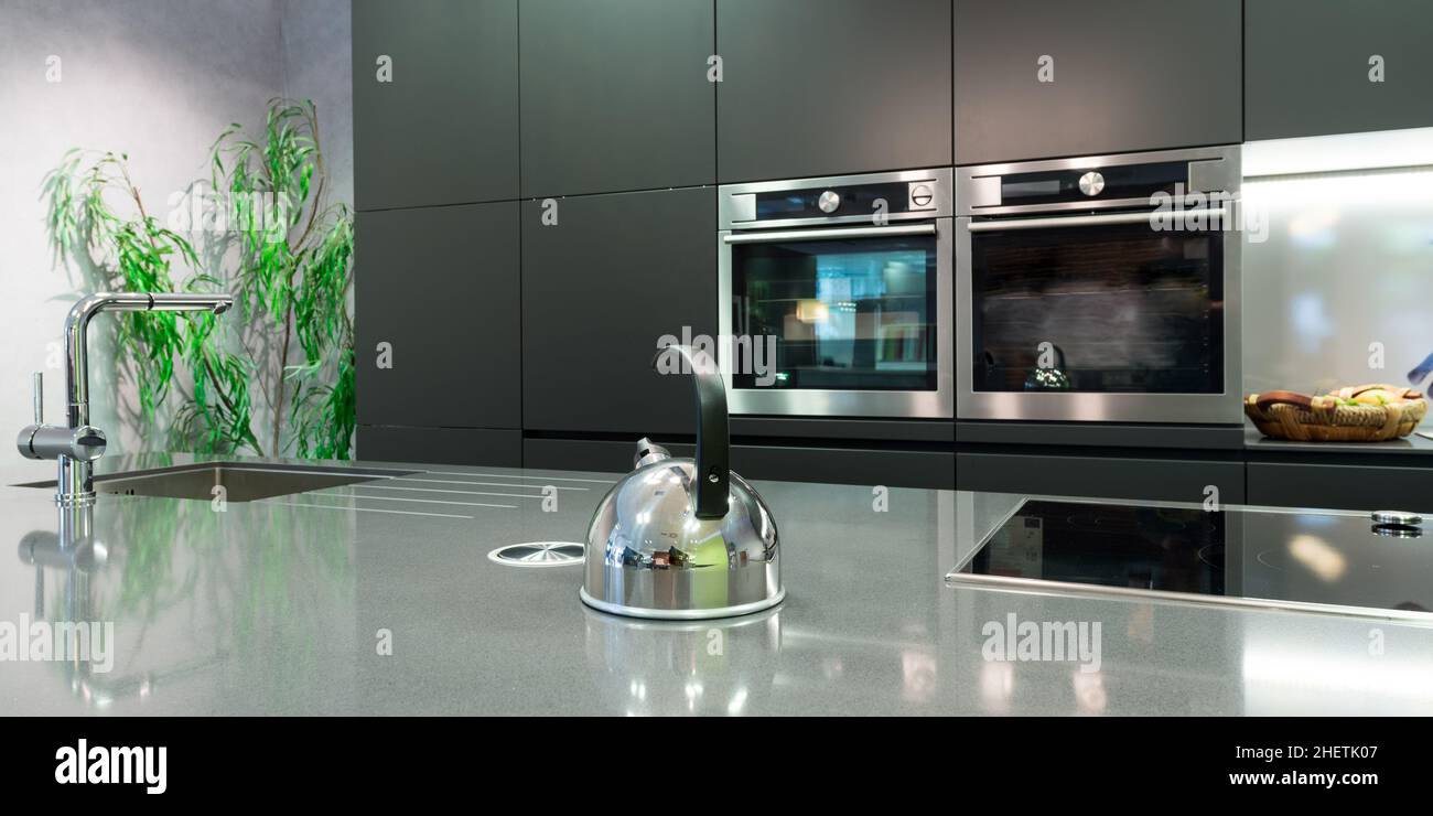 detail over work plate of modern kitchen with teapot and baking oven ...