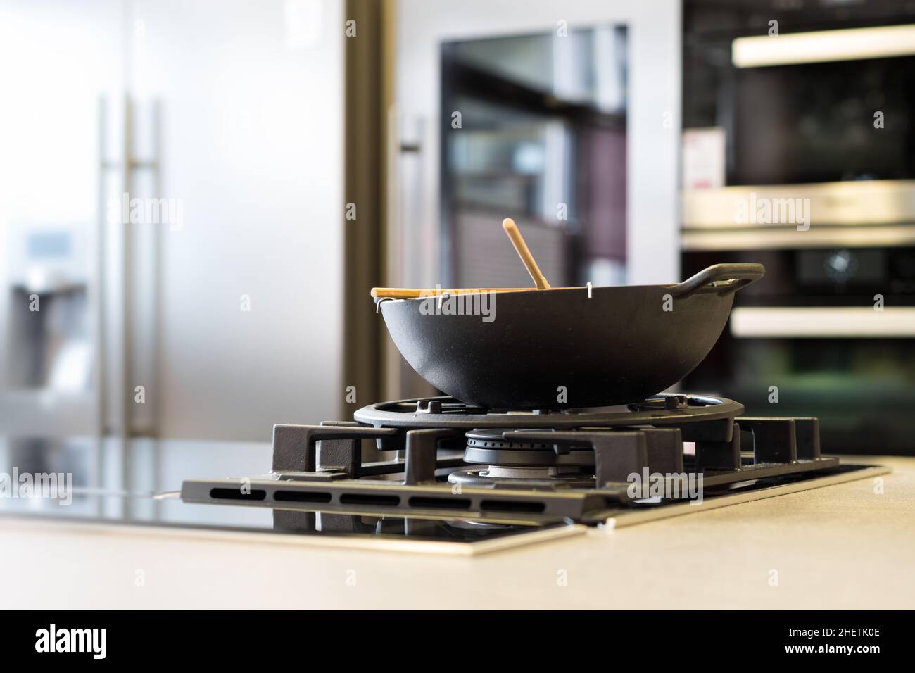 noodle wok on gas stove on workplate in modern kitchen Stock Photo - Alamy