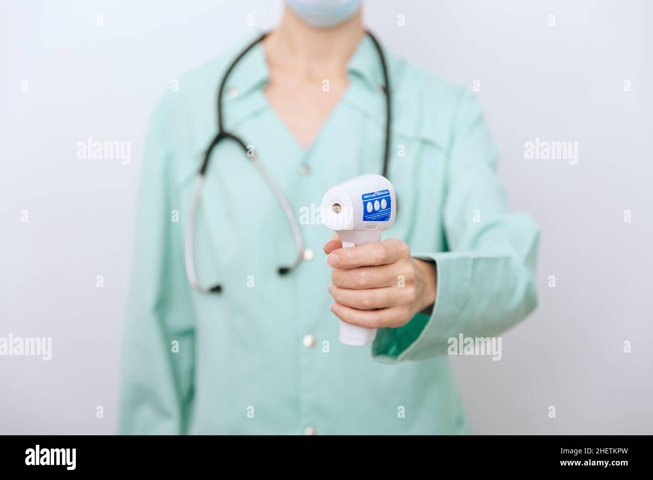 Temperature measurement gun in doctor hands. Close-up shot of doctor ...