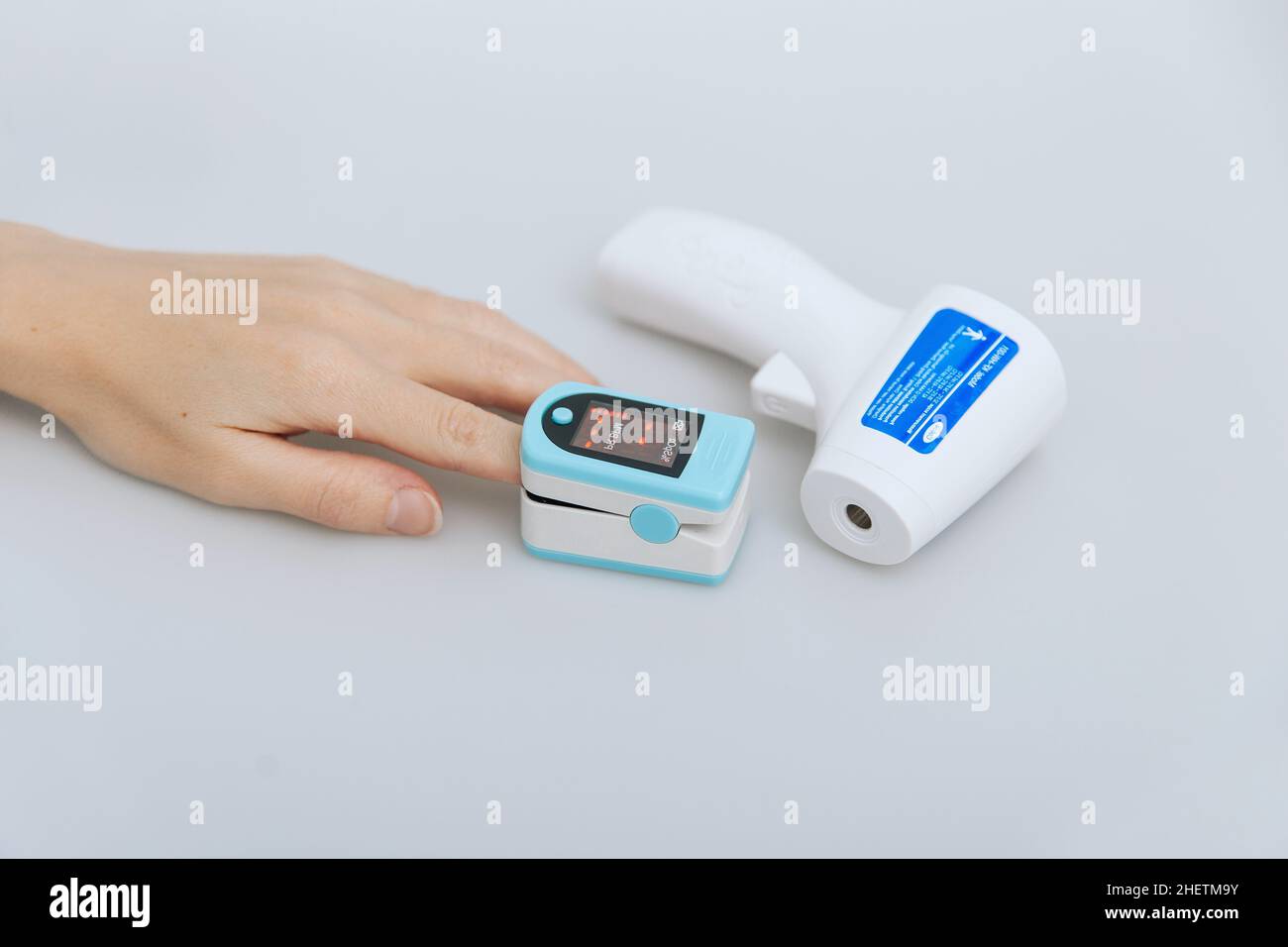 Pulse oximeter and thermometer gun on white background. Infrared ...