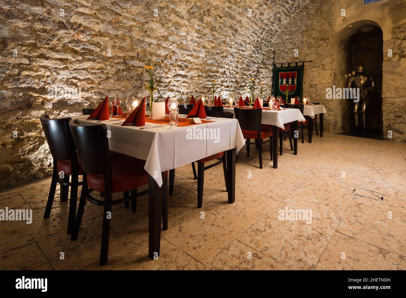 romantic arch stonewall in knight room with tables and candlelit Stock ...