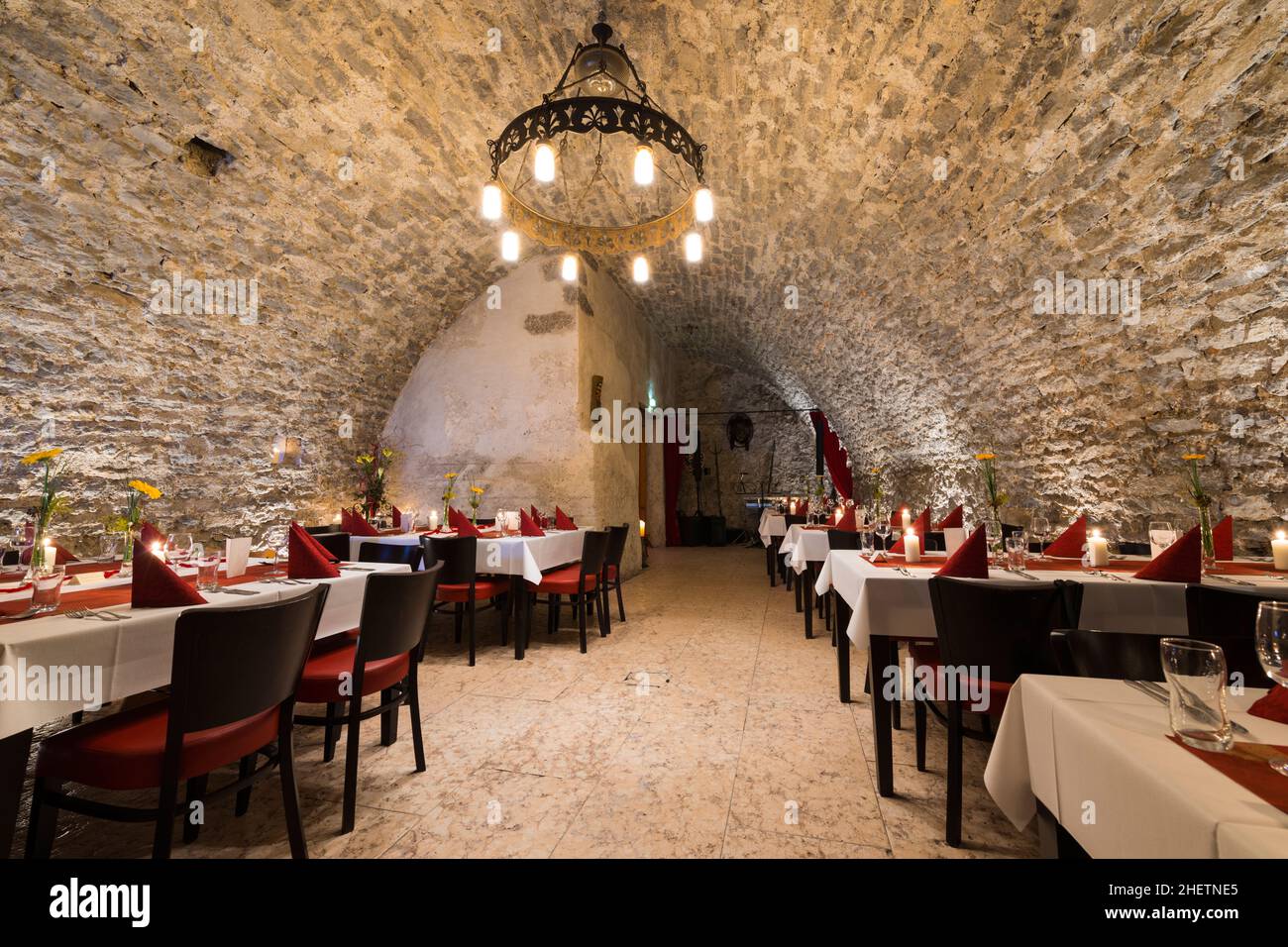 romantic arch stonewall in knight room with tables and candlelit Stock ...
