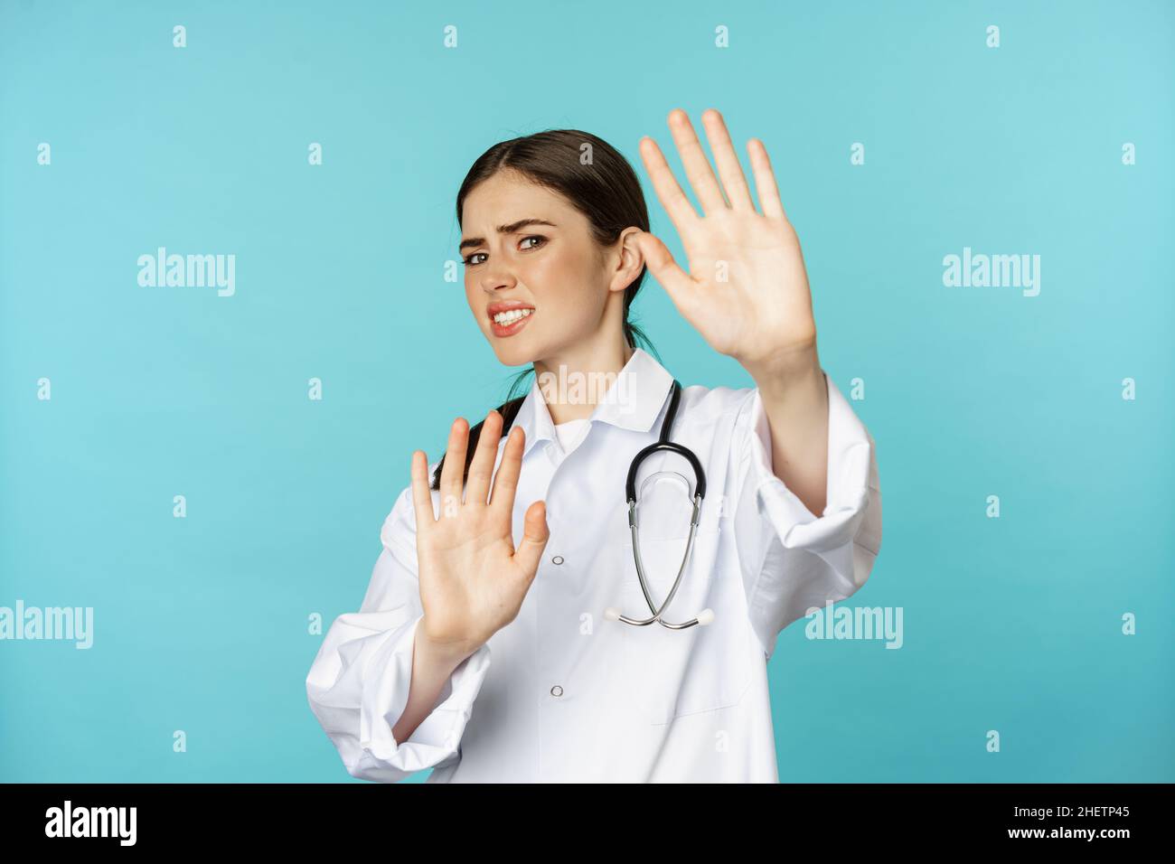 Image of woman doctor cringe, looking with dislike or aversion ...