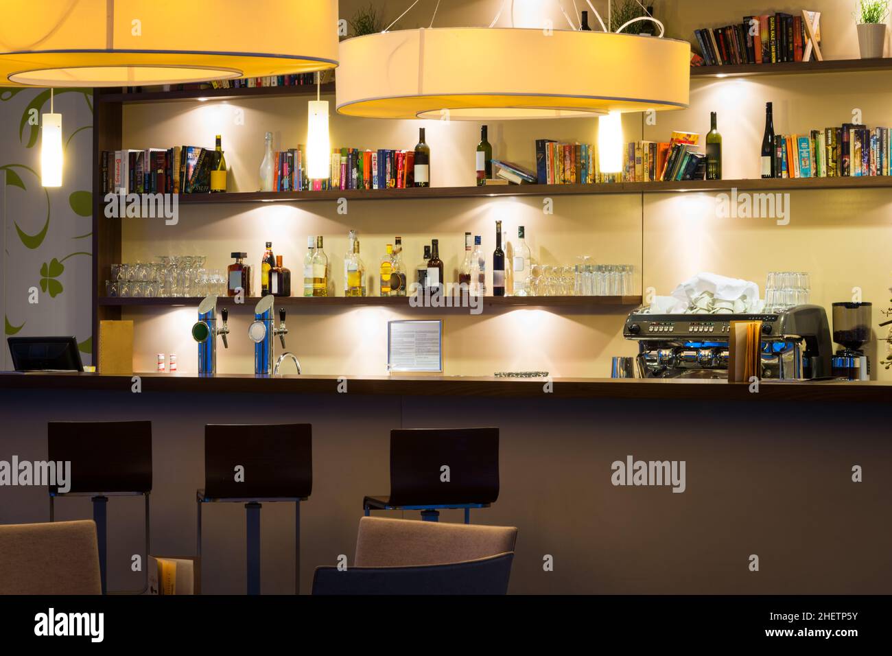 nice hotel lounge bar with bottle shelfs and seats, tables, lights ...