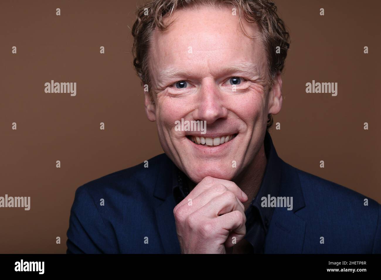 Portrait of a beautiful happy man in front of a colored background ...