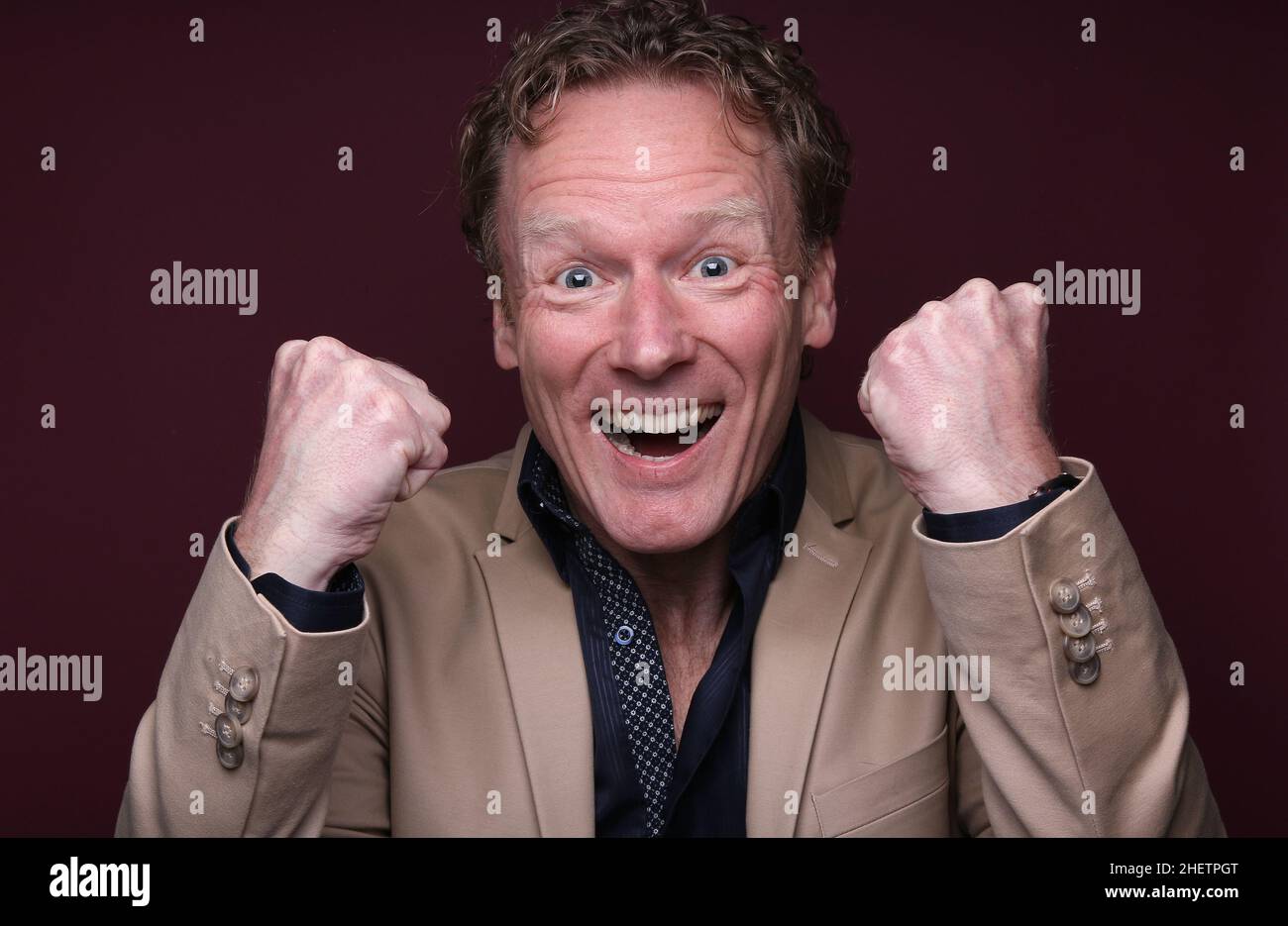 Portrait of a beautiful happy man in front of a colored background ...