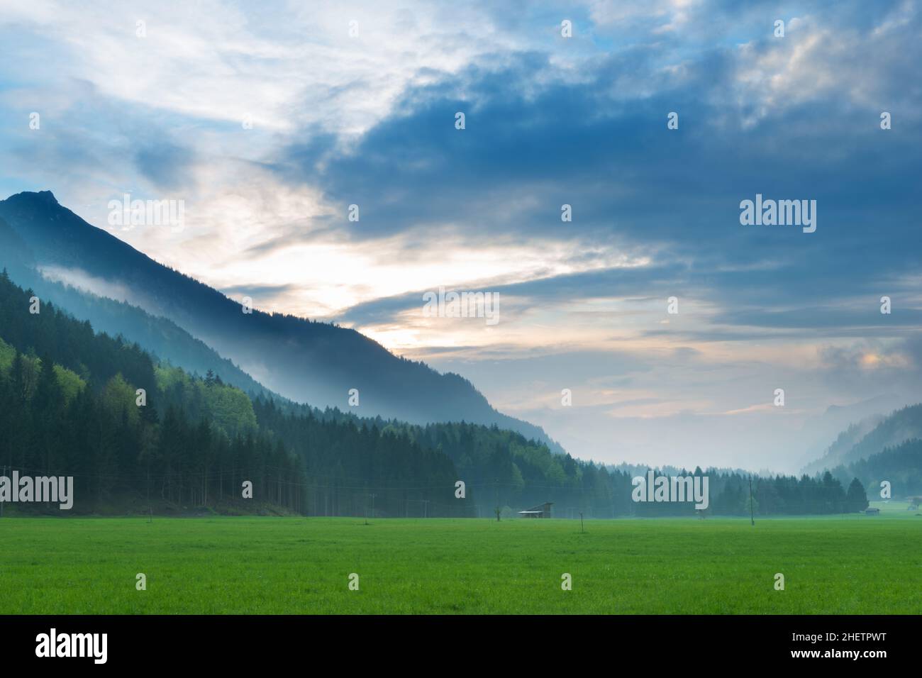 mystical sunset in tyrol alps with forest and dramatic sky Stock Photo ...