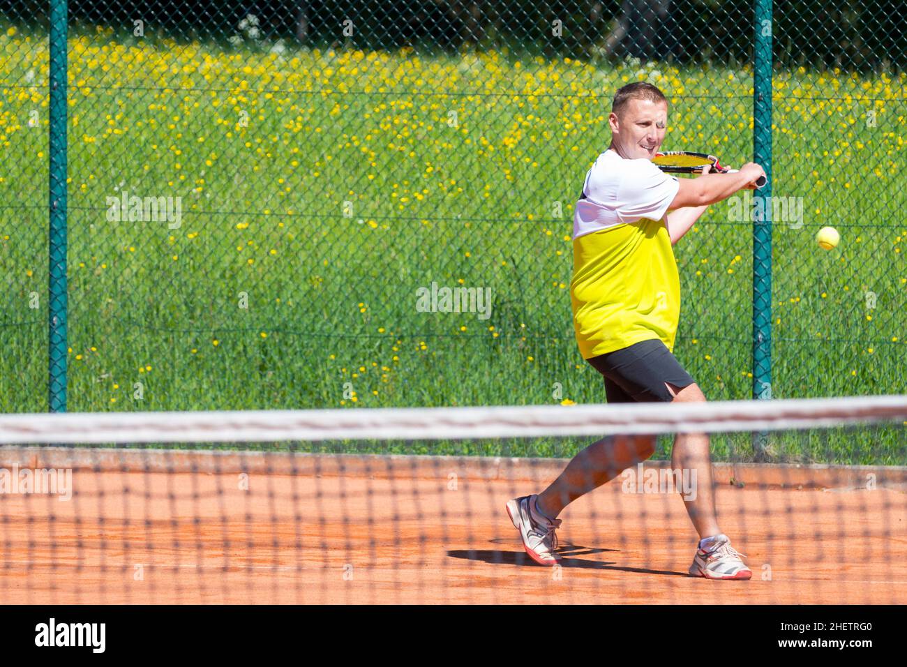 slice backhand of tennis player behind net Stock Photo - Alamy