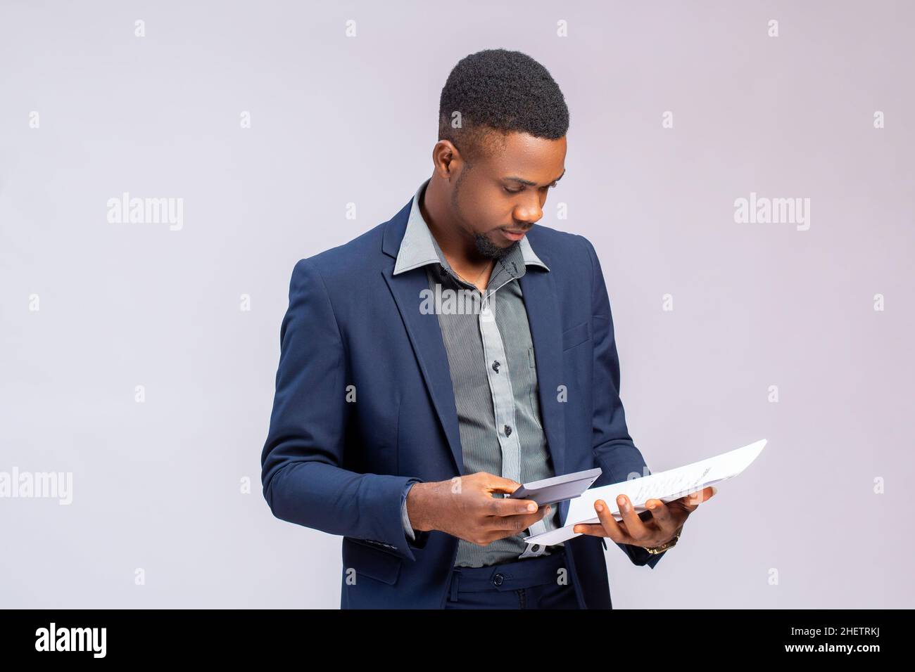 man feeling happy as he is calculating his invoice Stock Photo - Alamy