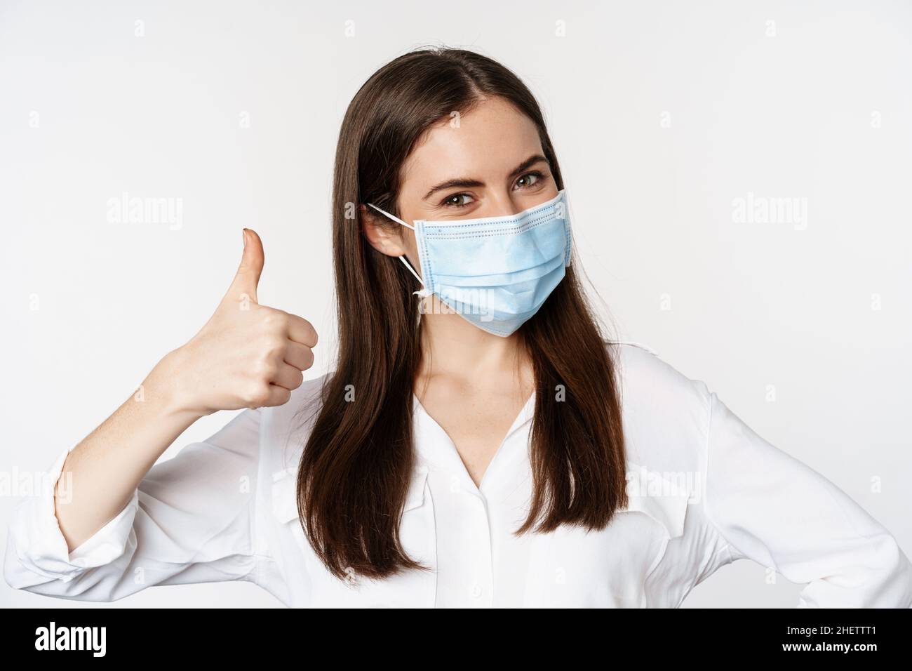 Close up portrait, face of woman in medical mask smiling, showing ...