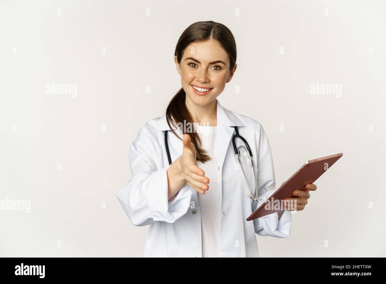 Friendly young female doctor, physician stretch out hand for handshake ...