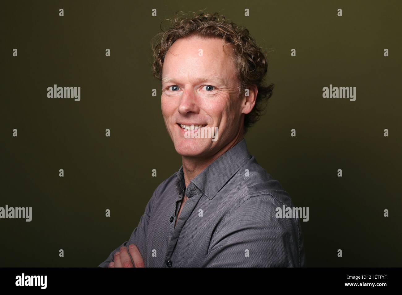 Portrait of a beautiful happy man in front of a colored background ...