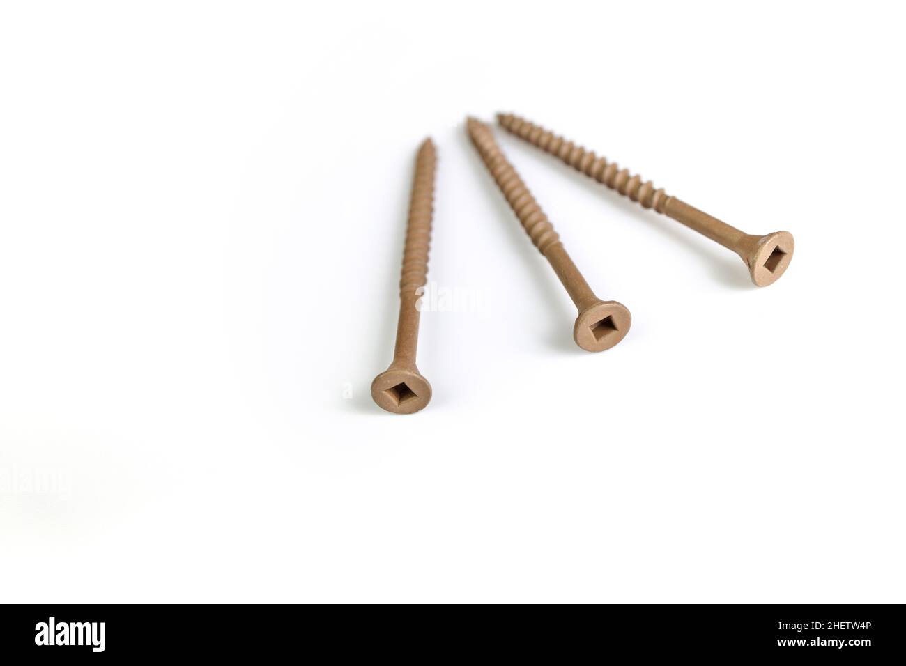 Brown Deck Screws Isolated on a White Background Stock Photo - Alamy