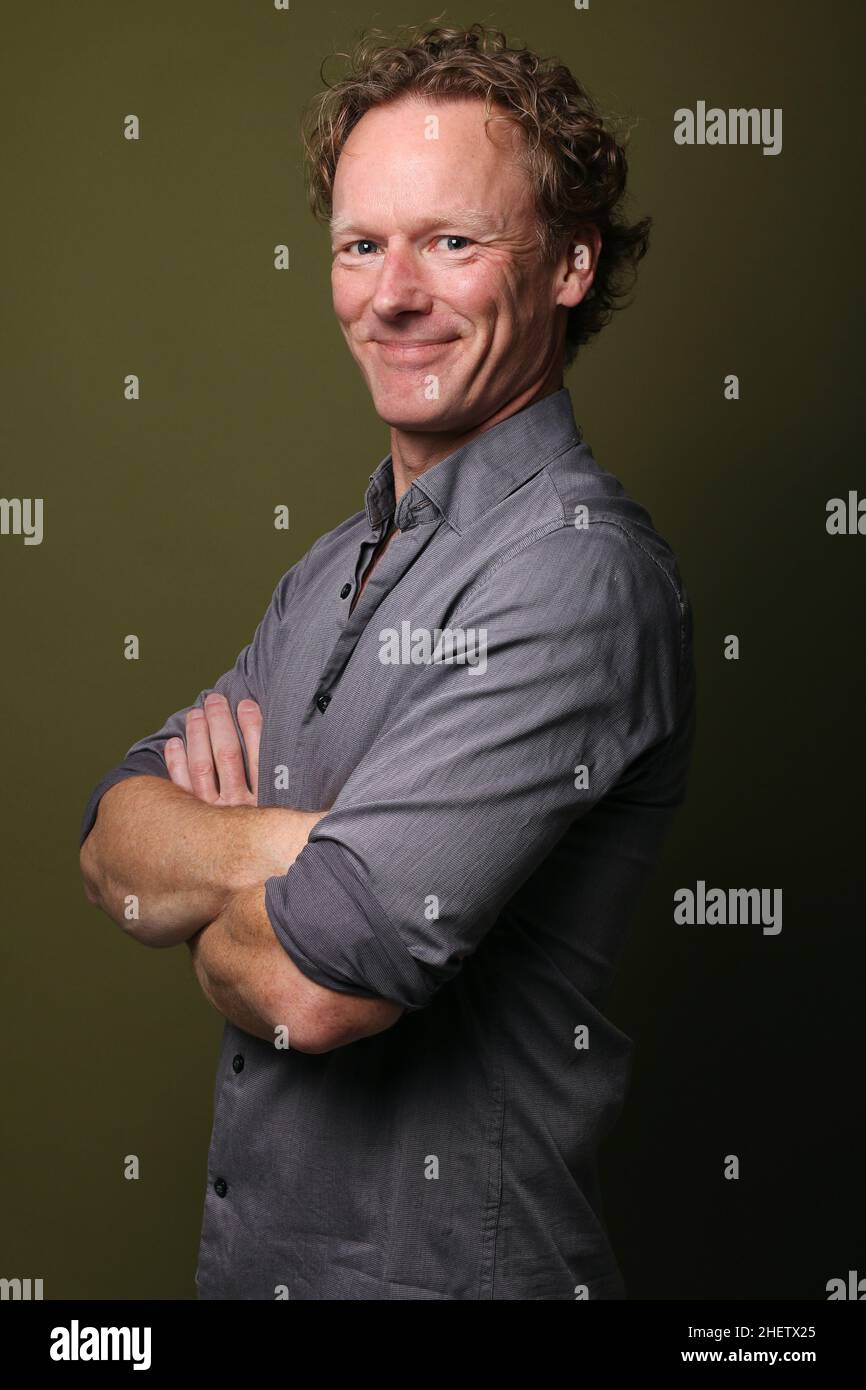 Portrait of a beautiful happy man in front of a colored background ...