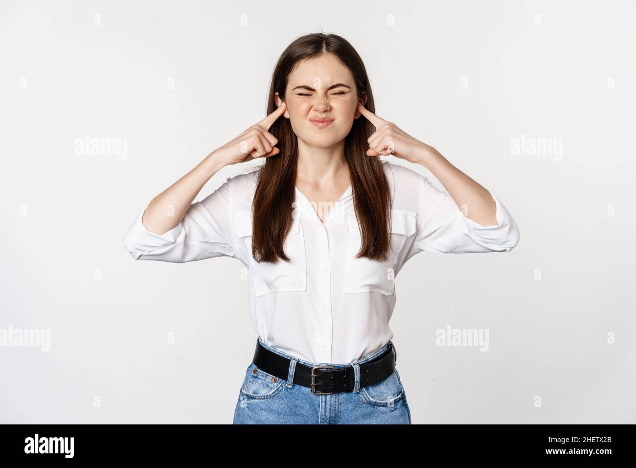 Annoyed girl shut ears from loud sound, discomfort of hearing smth ...