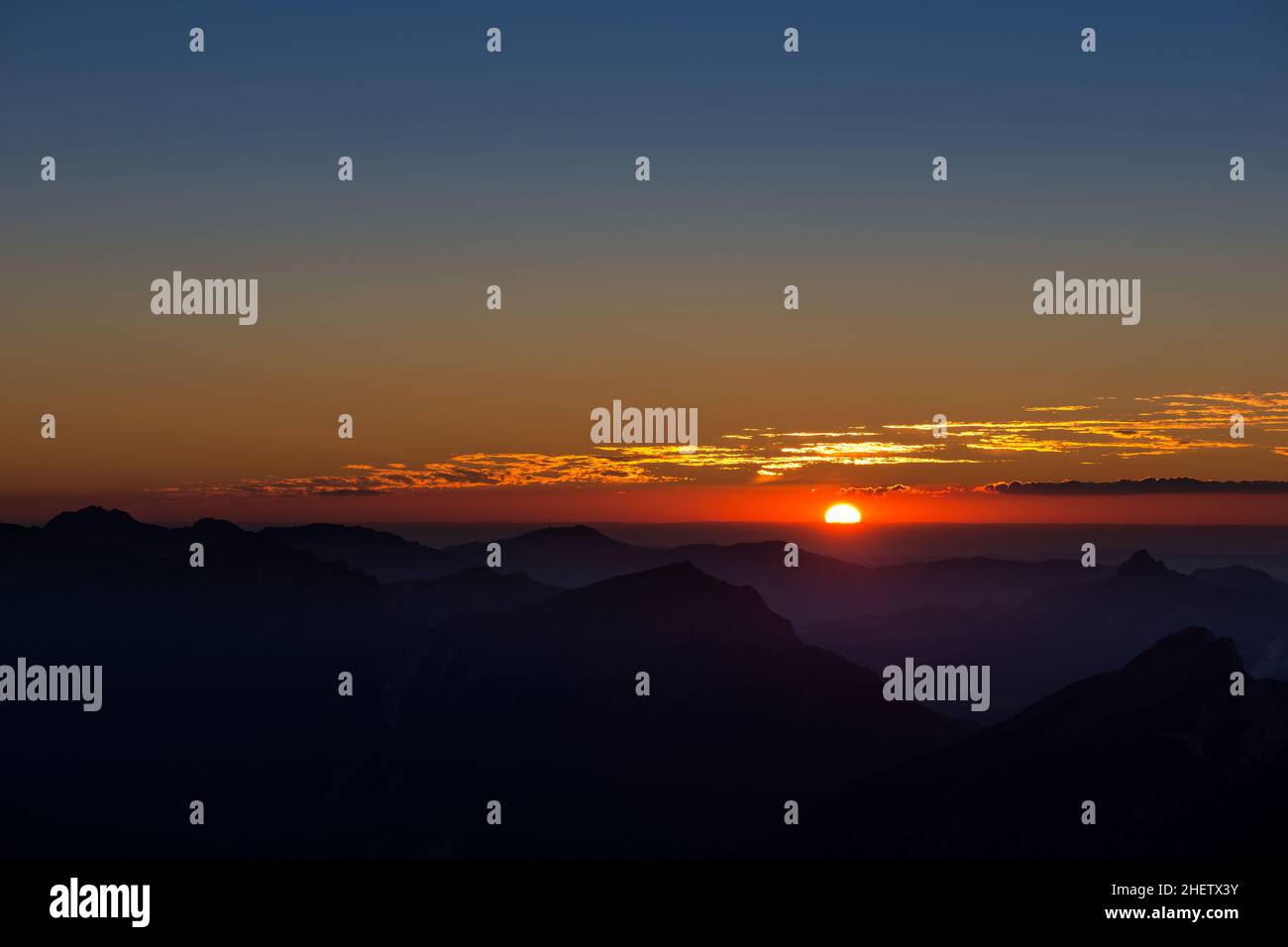 sunset in austrian mountain alps with moody sky and clouds Stock Photo ...