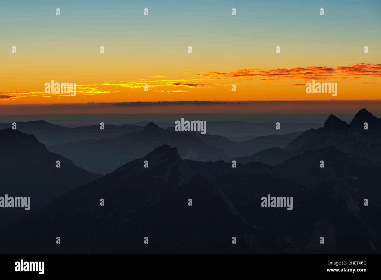 sunset mood in austrian mountains at orange cloudy sky Stock Photo - Alamy