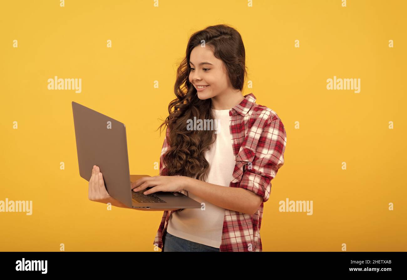 happy smart kid typing on laptop during school online lesson, modern ...