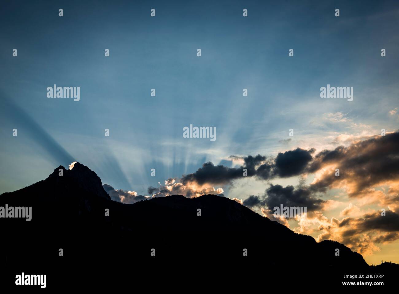dramatic cloudy sky with light ray of sun while sunset at mountains ...