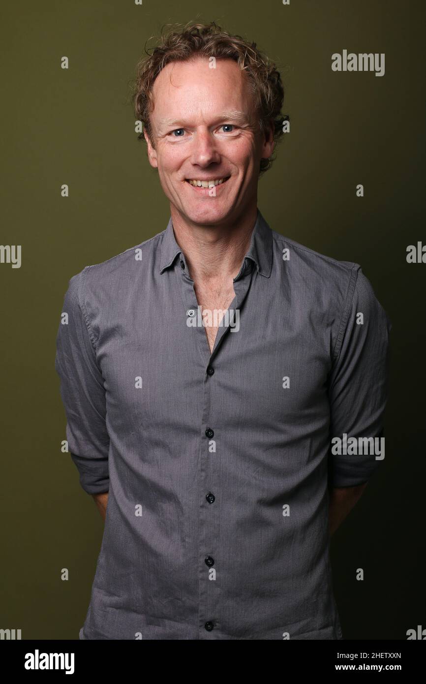Portrait of a beautiful happy man in front of a colored background ...