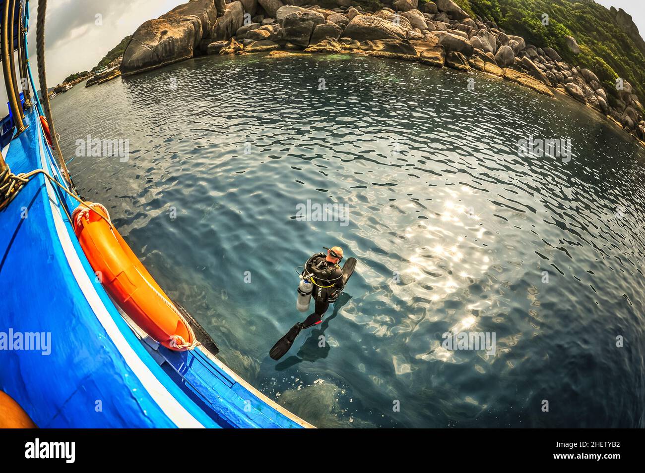KOH TAO, THAILAND - 26. MARCH 2018. Scuba diver jump into water with ...
