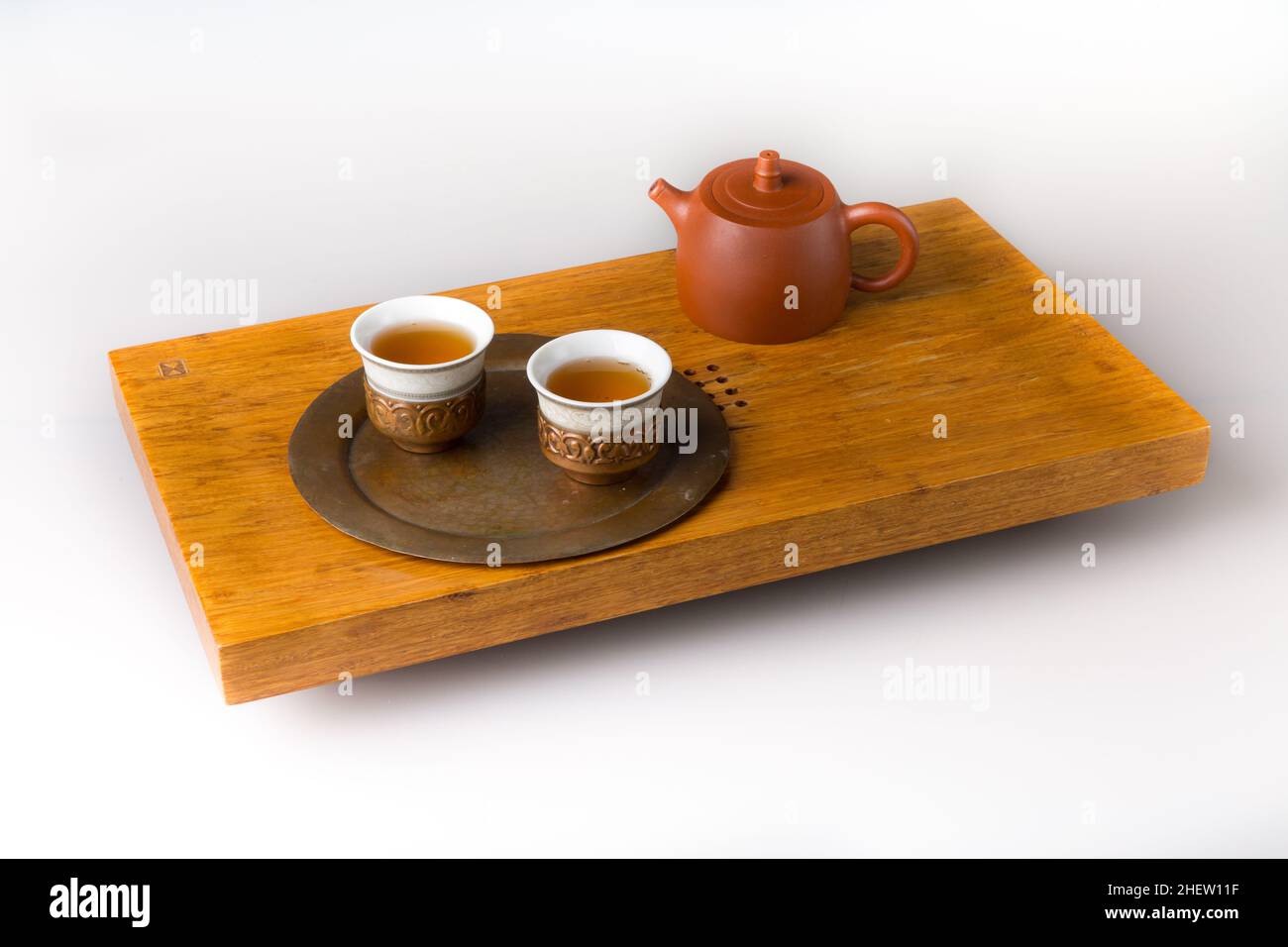 Ceramic teapot and three traditional cups for oriental tea drinking on ...