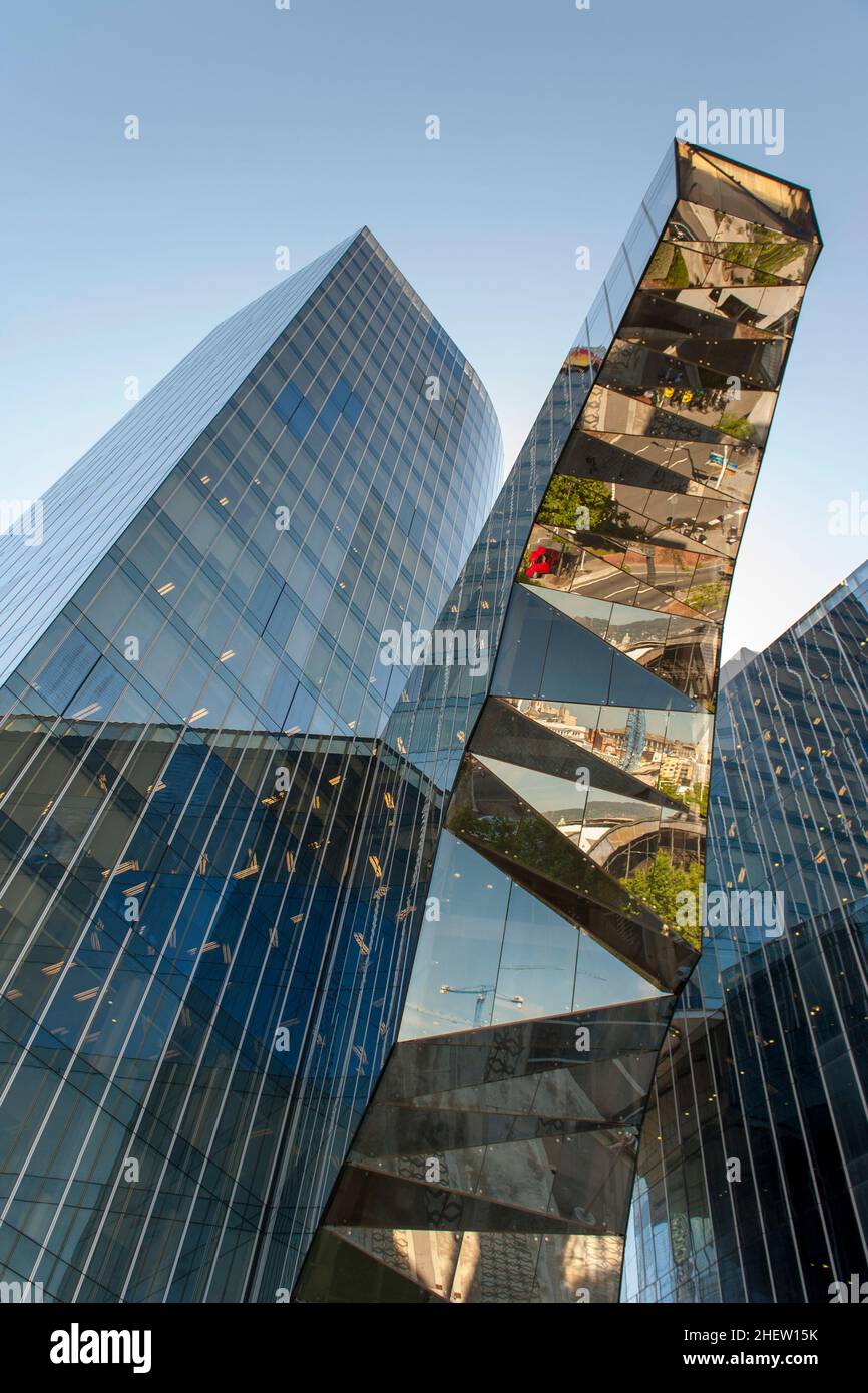 Low angle perspective looking up between two modern commercial ...