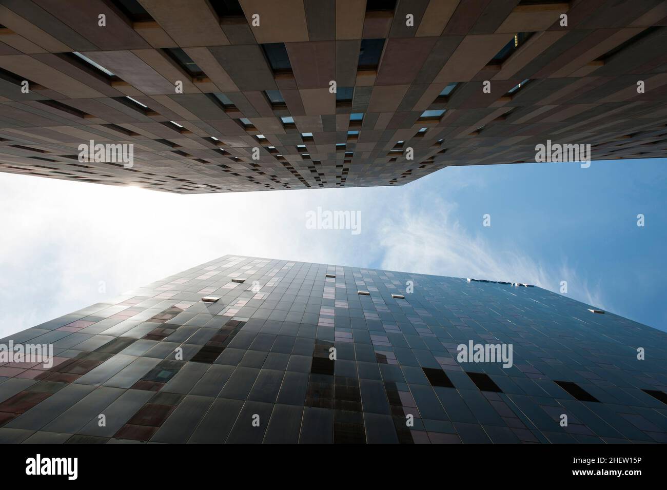 Low angle perspective looking up between two modern commercial ...
