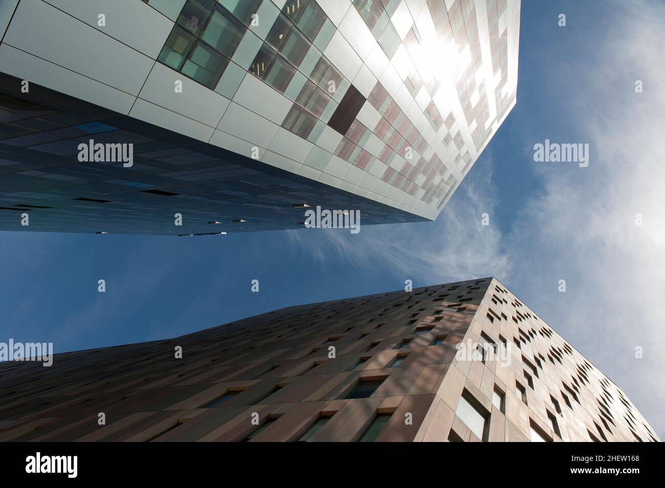 Low angle perspective looking up between two modern commercial ...