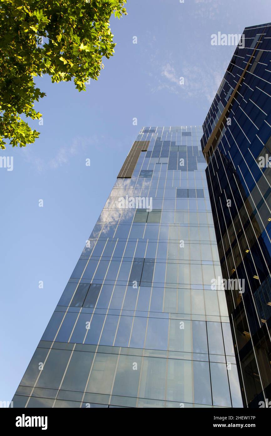 Low angle view of the exterior facade of a modern glass-walled ...