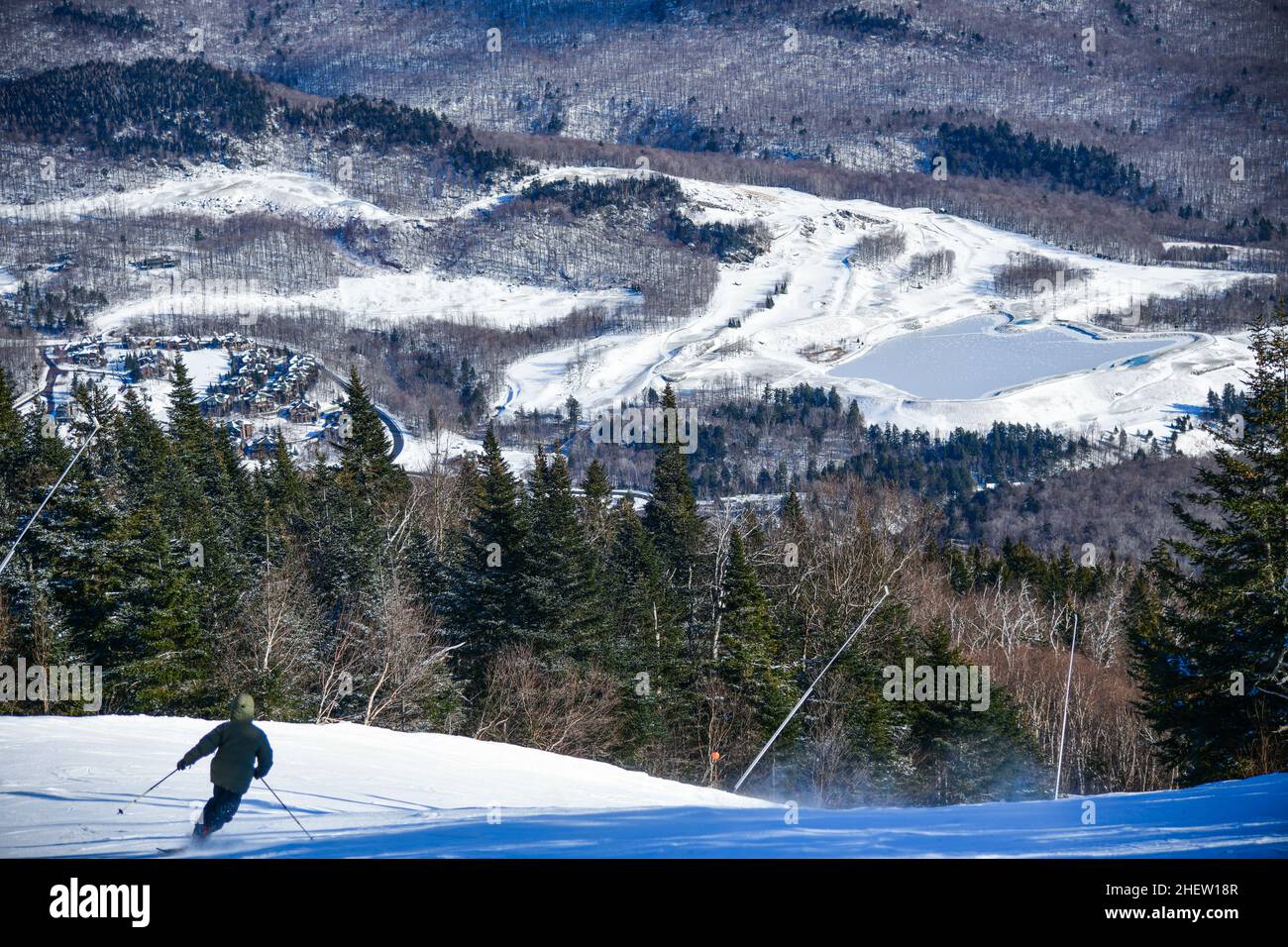 Breathtaking top view from the peak at Stowe Mountain Resort. Man skier ...