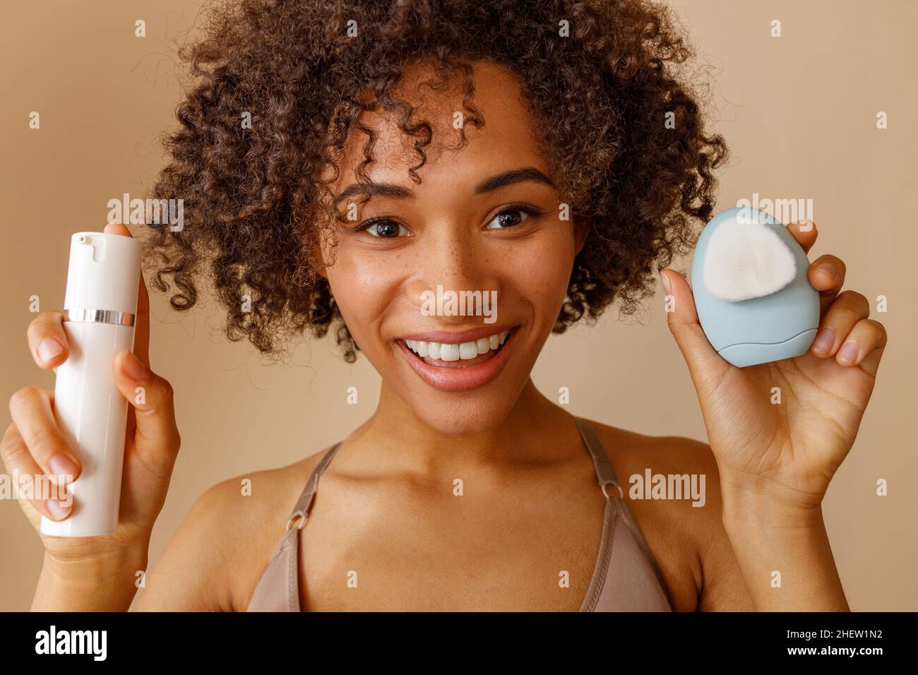 Cute lady demonstrating cosmetic tools in studio Stock Photo - Alamy
