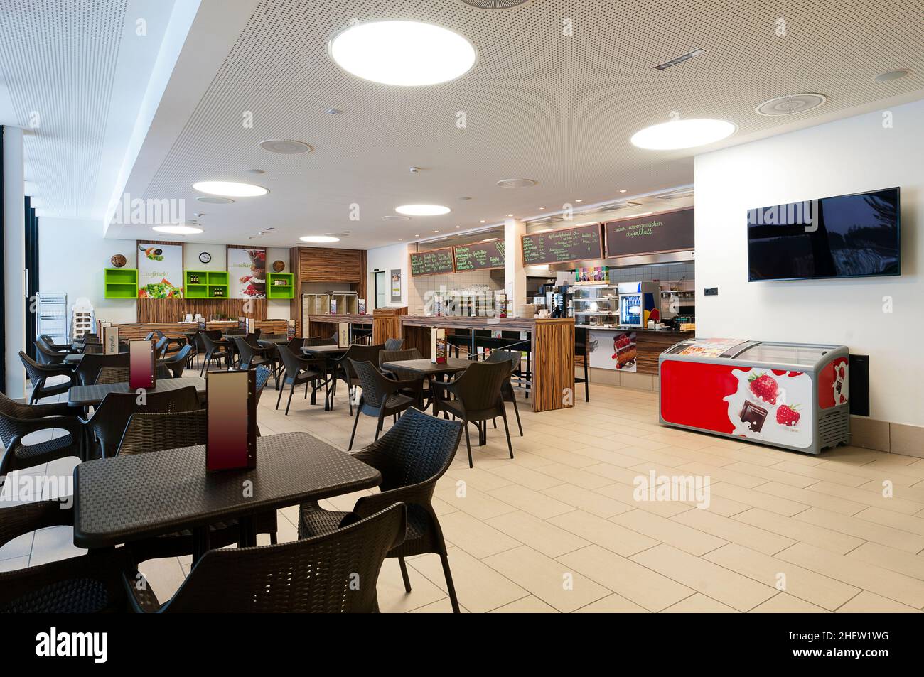 large self service restaurant with wood and rattan interior and long ...