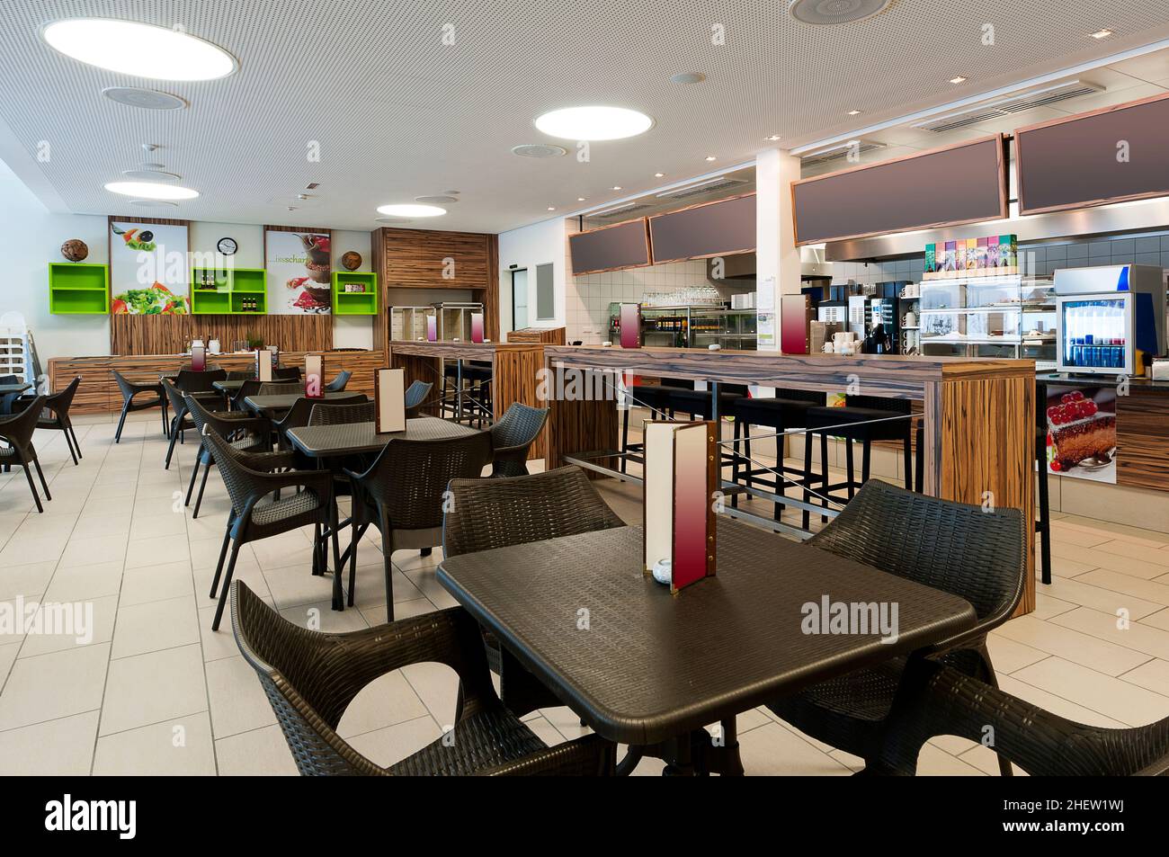 large self service restaurant with wood and rattan interior and long ...